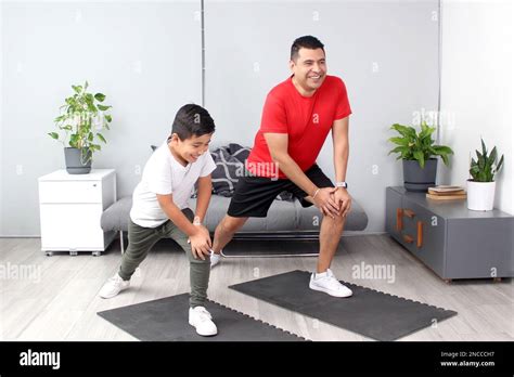 Overweight Latino Dad And Son Exercise At Home To Lose Weight And Be Healthy To Avoid Diseases