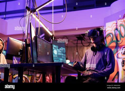 hacker wearing vr glasses immersed in simulation while doing illegal