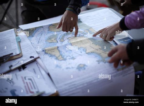 Instructors And Babes Look Over A Nautical Chart To Plan Out Their Route For Touring During