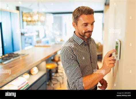 Man Adjusting Digital Home Automation Thermostat Stock Photo Alamy