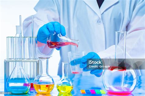 Laboratory Assistant Conducts Experiments With Chemical Liquids The Man Mixes The Substances