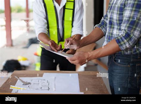 Architect Team Working With Blueprints For Architectural Plan Engineer Sketching A Construction