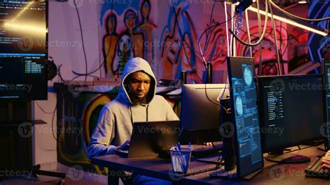 Hacker Arriving With Laptop In Hidden Base Deploying Viruses On Unaware Victims Computers