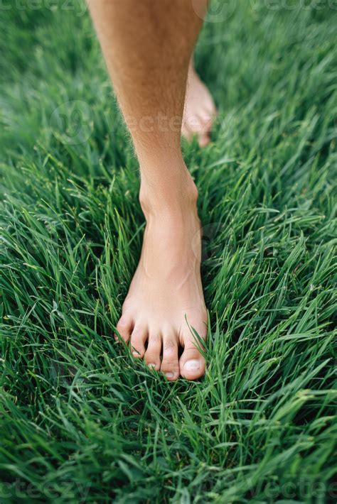 Barefoot Walking On Lush Green Grass In A Serene Outdoor Setting