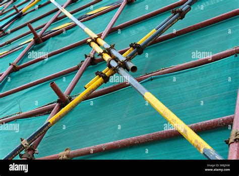 Scaffolding And Protection Netting On An Unfinished Building Stock Scaffolding And Protection Netting On An Unfinished Building Stock