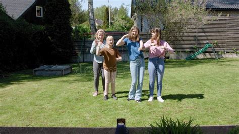 Close Up Of Three Young Girls Watching Tiktok Videos On Their Phones