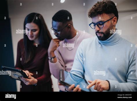 Multiracial Professionals Collaborating On Business Strategies Analyzing Statistics And