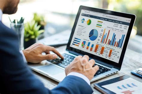 Business Professional Analyzing Visual Data Charts On Laptop In Office Environment With