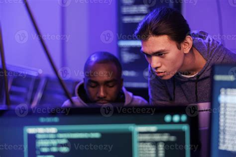 Hackers Analyzing And Discussing Malicious Code On Computer Screen