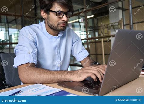 Young Indian Business Man Using Laptop Computer Working In Office
