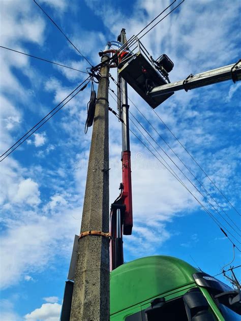 Utility Services Are Restoring Power Lines A Vehicle With A Lift And