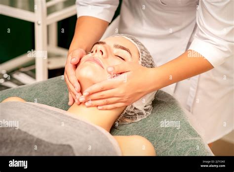 Facial Treatment Massage Beautiful Young Caucasian Woman With Perfect