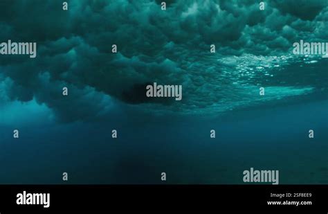 Man Surfer Falls Into The Water Underwater View Of The Person Falling