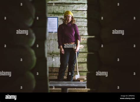 Woman Chopping Wood In Shed Stock Photo Alamy