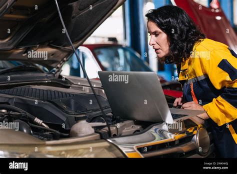 auto mechanic car engineer using laptop computer tuning ECU diagnosis analysis monitor engine ...