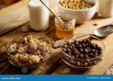 Healthy Morning Breakfast With Different Types Of Breakfast Cereals With Honey And Milk On Table