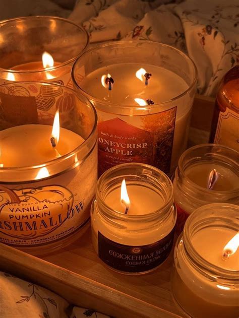 Several Candles Are Sitting In Glass Containers On A Tray