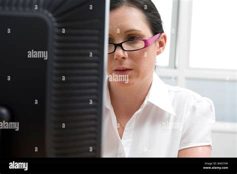 Female Office Worker Looking At Computer Monitor Stock Photo Alamy