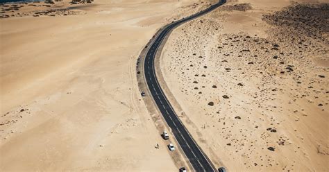 해변 한가운데에 있는 검은 아스팔트 도로의 공중 전망 사막 주변과 여행과 휴가의 개념 열대 경치 좋은 장소 야생 풍경에