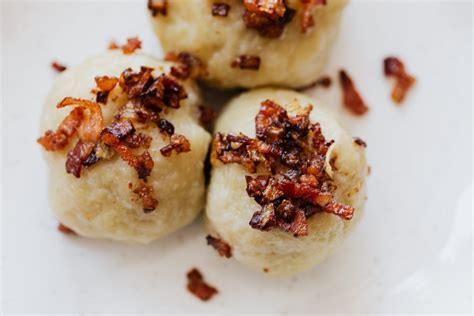 Delicious Potato Dumplings With Fried Bacon Slices On Round Plate