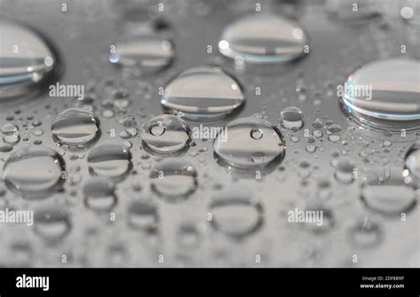 Macro Photography Of Water Drops On A Mirror Reflective Surface Stock
