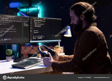 Programmer Putting Headphones While Implementing Security Measures