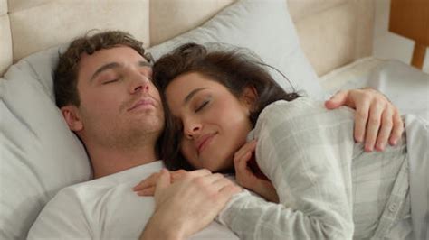 Couple Sleeping In Bed 