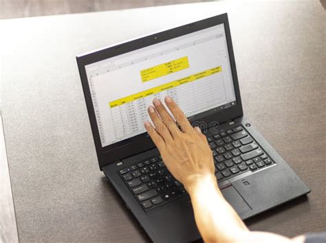 Shot Of A Woman Working On The Laptop Showing An Excel Sheet On The