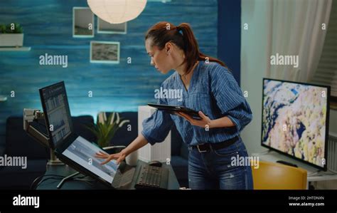 Woman Architect Holding Tablet Analyzing Blueprint And Maquette On Table Construction Planner