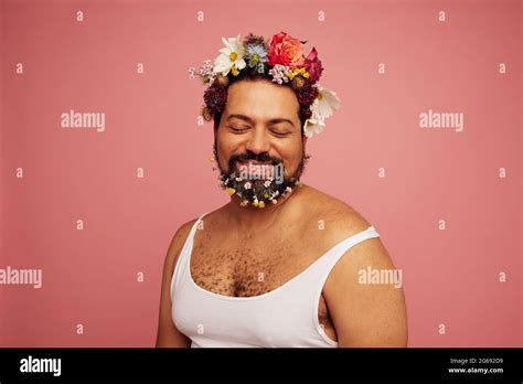 Non Binary Person Wearing Tank Top Posing On Pink Background Genderqueer Wearing Flowers On