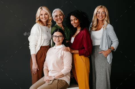 Multi Ethnic Group Of Beautiful Mature Women Bonding And Smiling