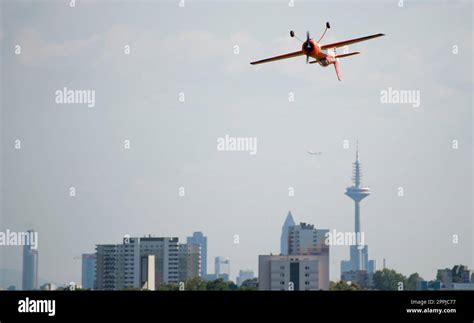 A Propeller Plane Flying Upside Down During An Aerobatic Display