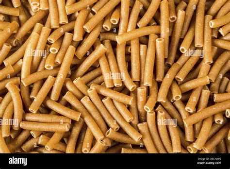 Pieces Of Wholewheat Macaroni Fill The Frame As These Brown Tubes Are