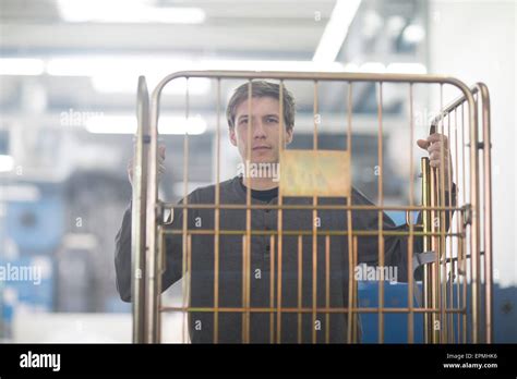Man In Factory Pushing Trolley Stock Photo Alamy