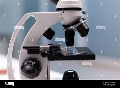 Close Up Of Chemical Microscope With Magnifying Glass For Microbiology Experiment And