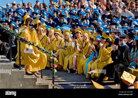 Wearing Caps And Gowns Two High School Senior Class Co Valedictorians