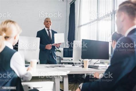 젊은 아프리카계 미국인 사업가 들고 노트북을 웃 고 보고 사무실에서 동료의 낮은 각도 보기 경영자에 대한 스톡 사진 및 기타 이미지 경영자 기업 비즈니스 남자