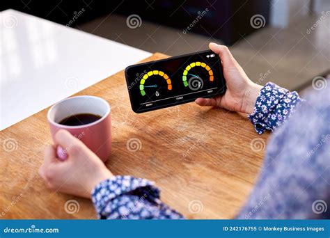 Close Up Of Woman Holding Smart Energy Meter In Kitchen Measuring Domestic Electricity And Gas