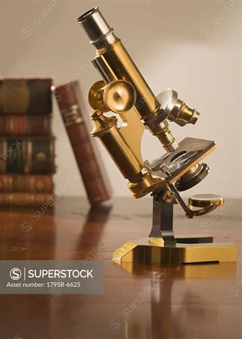 Old Fashioned Microscope On Table Superstock