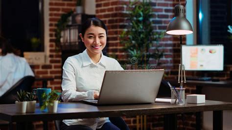 Portrait Of Smiling Businesswoman Doing Computer Tasks For Team Project