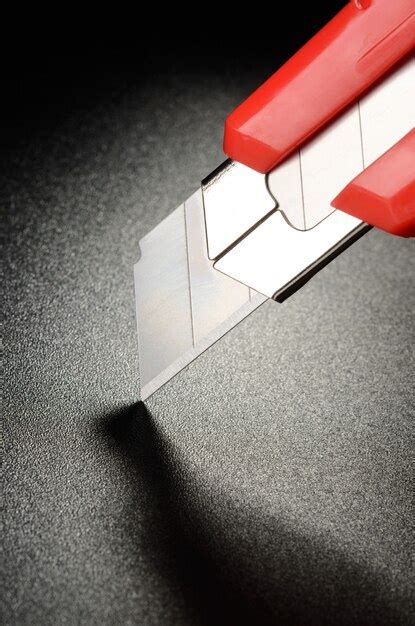Premium Photo Red Cutter On A Black Background
