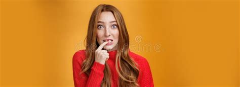 Silly Cute Redhead Woman Making Innocent Oops Expression Holding Finger On Lip And Looking