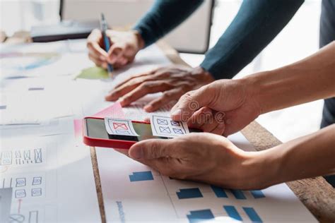 Group Of Ux Developer And Ui Designer Brainstorming About App Interface Design At Modern Office