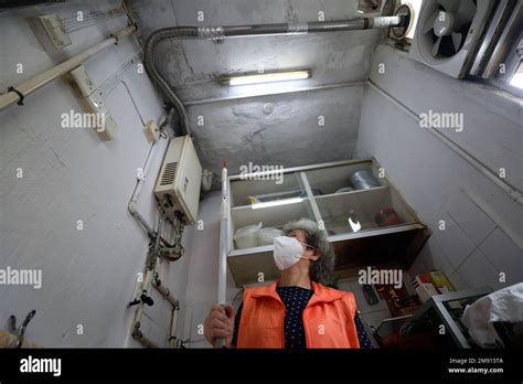 Public House Resident Chan Tai Tai 75 Years Old Points Out One Of The Leaking Spots At Her