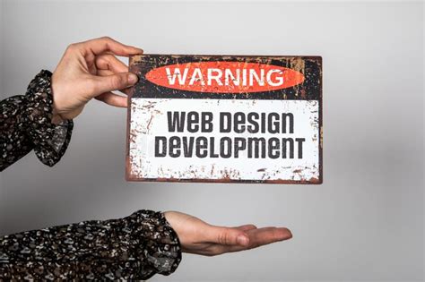 Web Design Development Concept Warning Sign With Text In Woman Hands Stock Photo Image Of