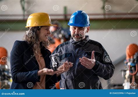 Female Engineering Manager And Mechanic Worker Doing Routine Check Up In Industrial Factory