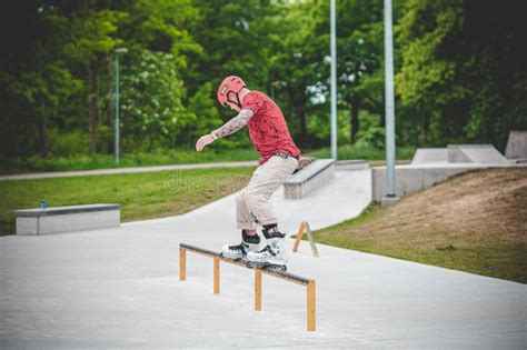 Closeup Shot Of An Inline Skater In A Skating Rink Practicing Moves With Trees In The Background