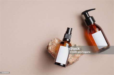 Spa 천연 유기농 화장품 포장 디자인 바디 로션과 샴푸 디스펜서 병 모형을 베이지 색 배경에 돌로 호박 색 유리 스프레이 병 0명에 대한 스톡 사진 및 기타 이미지