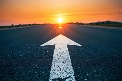 A Long Road Leading To A Bright Sunrise Symbolizing A Journey Towards