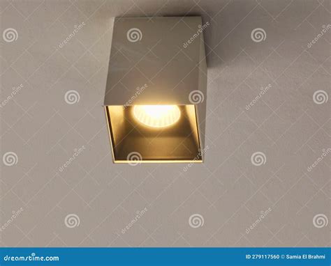 A Square Lamp And An Advertising Monitor On A White Office Ceiling Round Video Surveillance